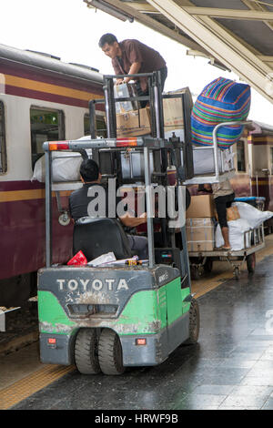 Men loaded packages into the train through the window of the car ...