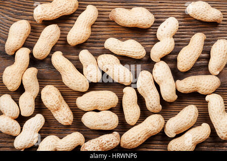 peanuts scattered on a wooden table. Close-up peanuts beans. Nut ...
