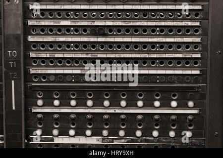 Old analog telephone switchboard system connection panel with wire ...