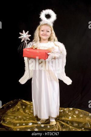 Christkind mit Weihnachtsgeschenk - christ child with presents Stock ...