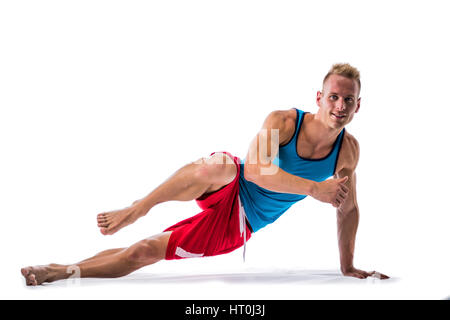 Handsome young bodybuilder laying down on the floor, showing ripped abs ...