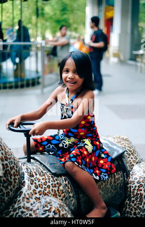Cute little girl driving children's car outdoors Stock Photo - Alamy
