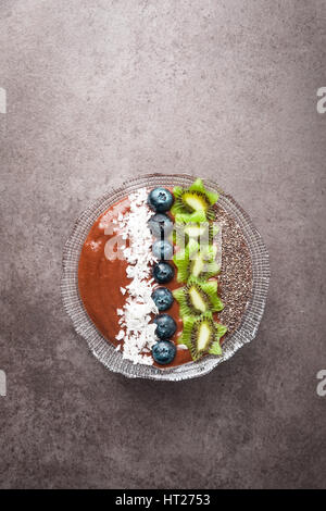 Healthy smoothie for breakfast, kiwi, chia, flakes and green vegetables ...