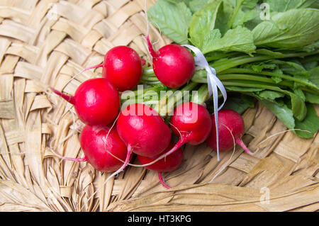 Bunch of radishes with leaves on a wicker table Stock Photo - Alamy