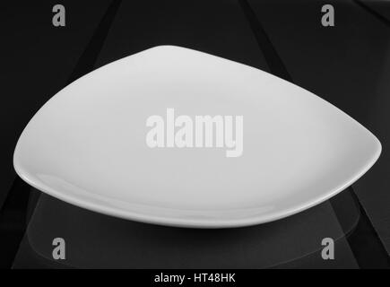 Triangular shallow porcelain bowl for serving food Stock Photo - Alamy