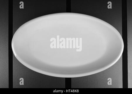 Porcelain round square shallow dish. Front view Stock Photo - Alamy