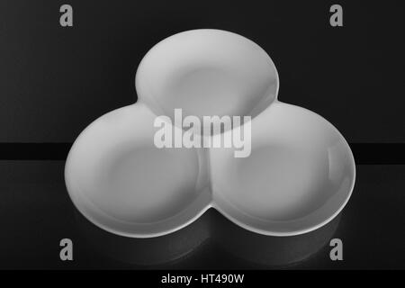 Round porcelain bowl with three compartments Stock Photo - Alamy
