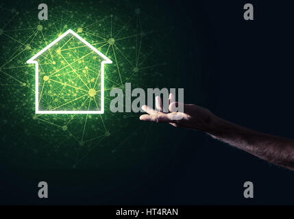 Male hand pointing to the glowing home icon or symbol Stock Photo - Alamy