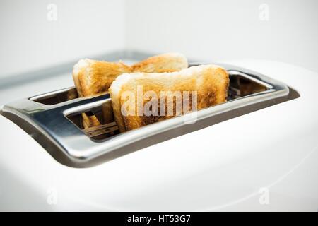 Modern toaster with bread slices on white background Stock Photo - Alamy