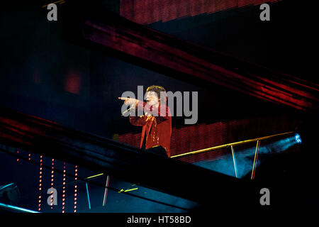 Crowd at a concert looking at the stage. Blurred backgorund. Red ...