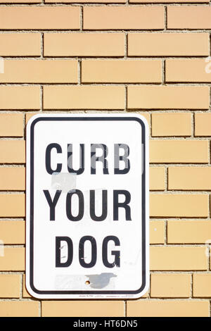 "Curb your dog" sign attached to a brick wall. New York City, USA Stock ...