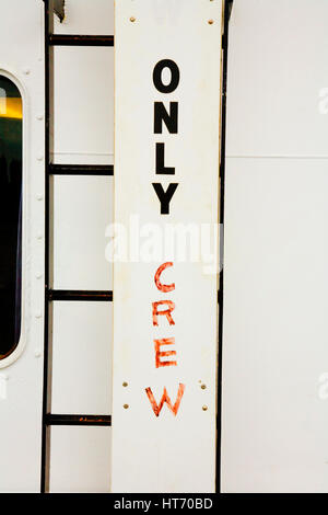 Crew only sign on white door onboard ferry cruise ship Stock Photo - Alamy