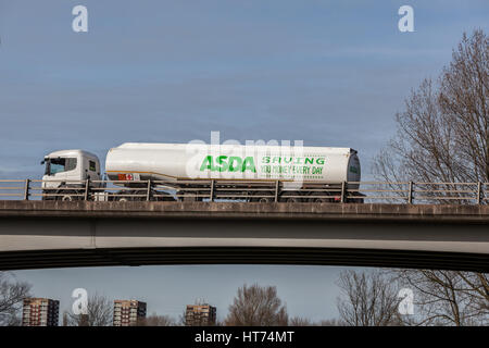 Asda supermarket fuel delivery tanker behind Scania truck on motorway ...