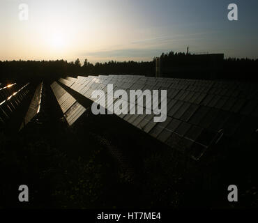 The field of solar panels with an energy storage station located in the ...