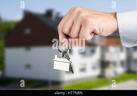 Keys and house chrome pendant on home project Stock Photo - Alamy