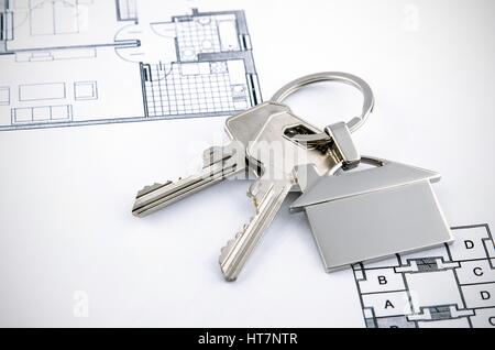 Keys and house chrome pendant with home shape isolated on white ...