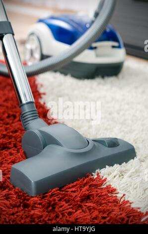 Close up of vacuum cleaner on a wooden background with copy space ...