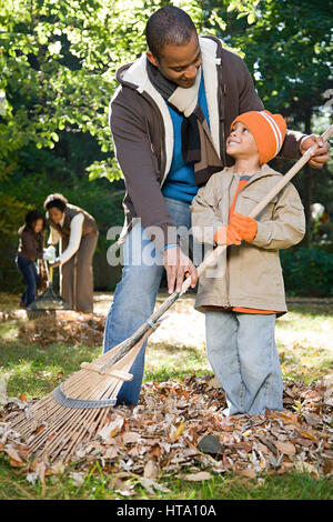 Father with boy child sweeping up mess, family cleaning together and ...