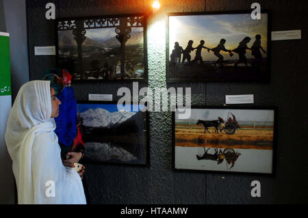 Visitor takes keen interest in art works during the Peshawar Literature ...