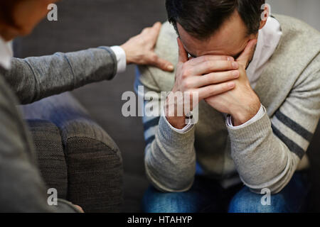 Sad Man Crying During Visit To Psychologist For Therapy Session Stock ...