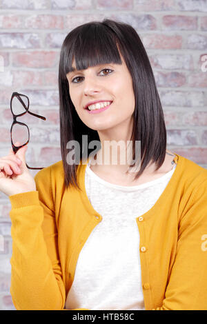 Fashionable pretty brunette wearing bright yellow clothes Stock Photo ...