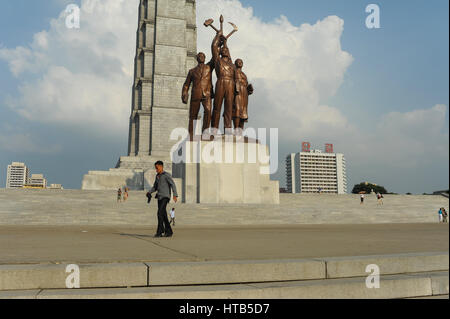PYONGYANG, North Korea - A man walks past portraits of North Korean ...