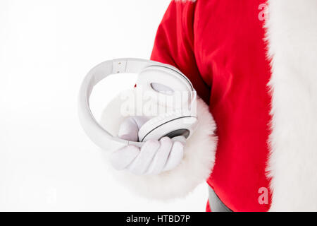 Santa Claus hand showing headphones Stock Photo - Alamy
