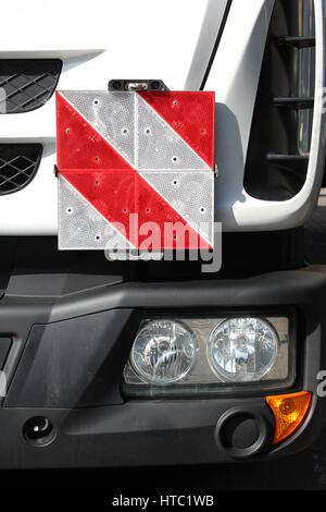 Reflective red and white striped warning road sign isolated in a ...