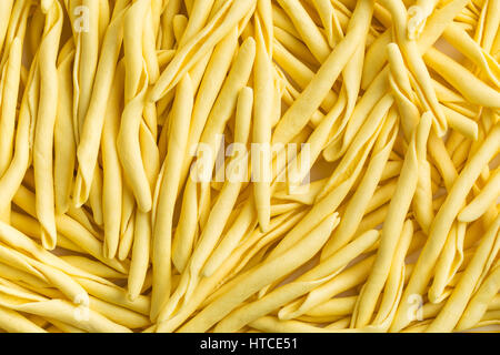 A top view of raw penne pasta on a white background Stock Photo - Alamy