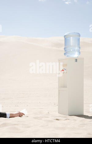 Person reaching for water cooler in desert Stock Photo - Alamy