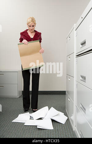Woman dropping files Stock Photo - Alamy