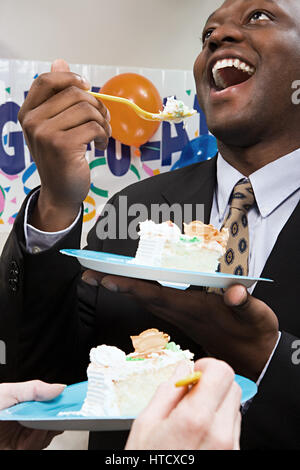 Office workers eating party cake Stock Photo - Alamy