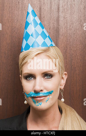 Businesswoman with icing on her face Stock Photo - Alamy