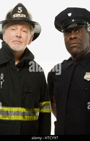 portrait of male African American firefighter standing in front of fire ...