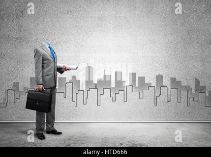 Headless engineer man with papers and case in hand against construction ...