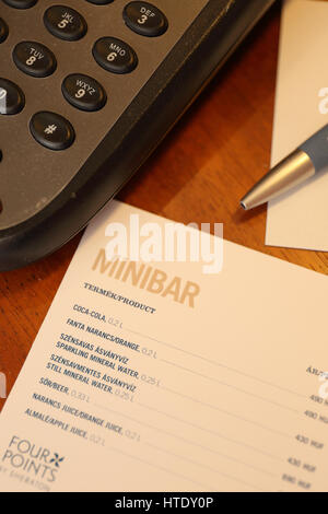 Hotel room mini bar menu with phone and pen Stock Photo - Alamy