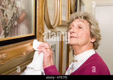 Woman polishing picture frames Stock Photo - Alamy