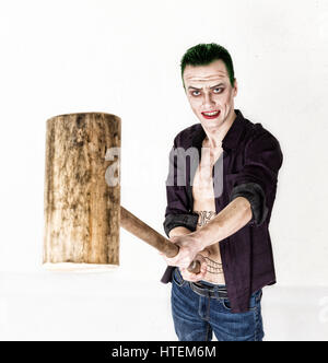 Scary halloween clown with menacing smile holding sack dark room with ...