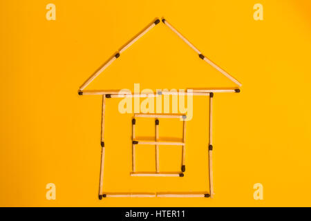 conceptual picture is not a big House of matches on a yellow background ...