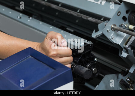 Technician with plotter cleaning tool in office Stock Photo - Alamy