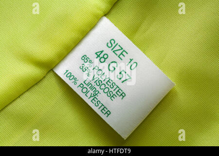 100% polyester label in woman's red clothing with wash care symbols and ...
