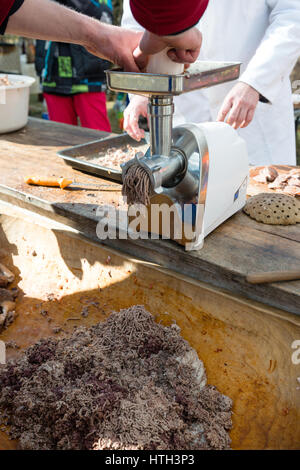 Grinding meat and spices for sausage Stock Photo - Alamy