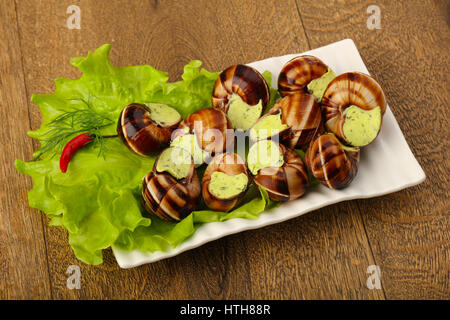 Escargot with cheese cream on salad leaves Stock Photo - Alamy
