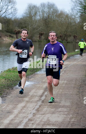 People running alongside the River Thames at Albert Embankment, London ...