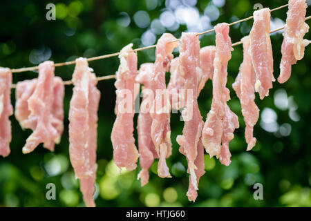 Strips of pork drying in the sun, traditional food preservation Stock ...