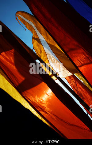 Brightly coloured banner flags flapping against blue sunny sky Stock ...