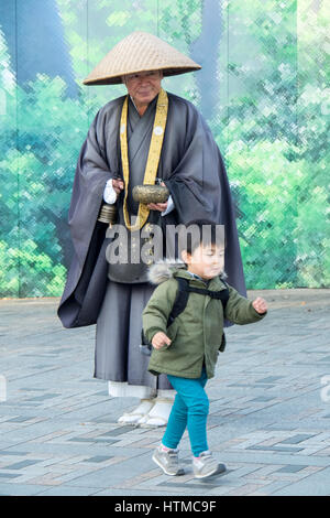 Japanese Buddhist monk in tradtional dress with a small bowl asking for ...