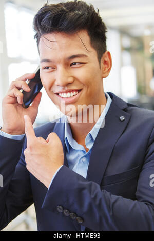 Asian start-up as businessman calling with telephone in the office ...