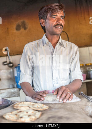 Indian men eating typical South Indian food with their hand in an ...