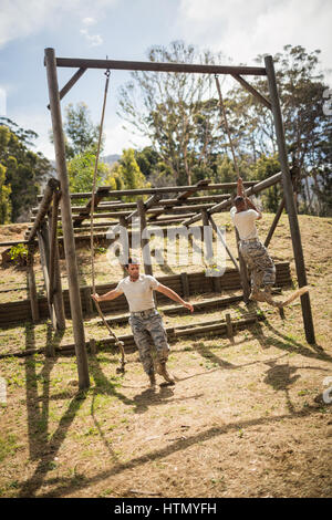 Military soldiers training rope climbing at boot camp Stock Photo - Alamy